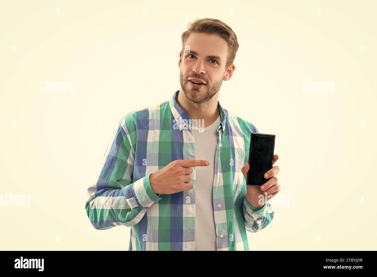 man showing phone screen on background, pointing finger. photo of man ...