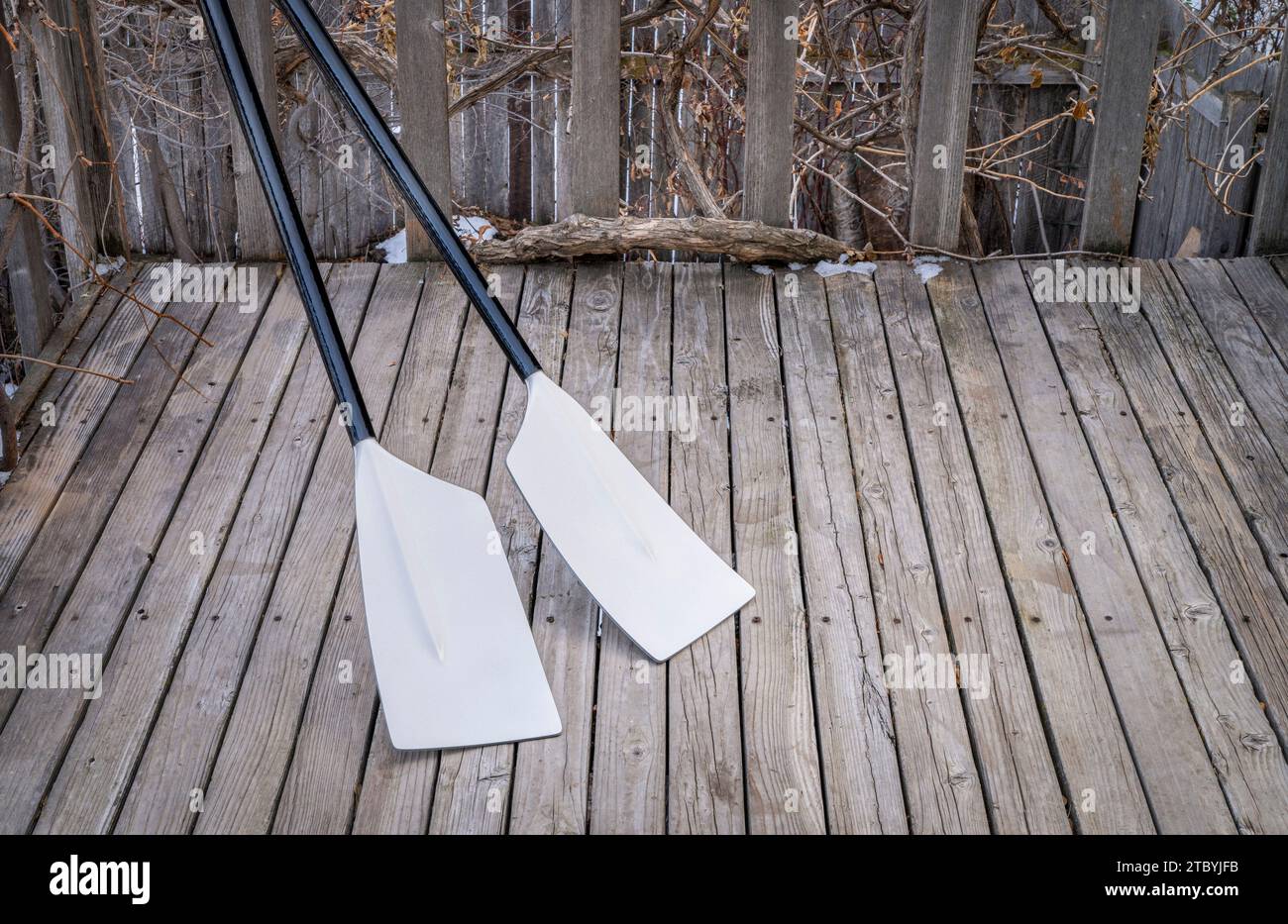 blades of hatchet sculling oars against grunge, rustic wooden deck ...