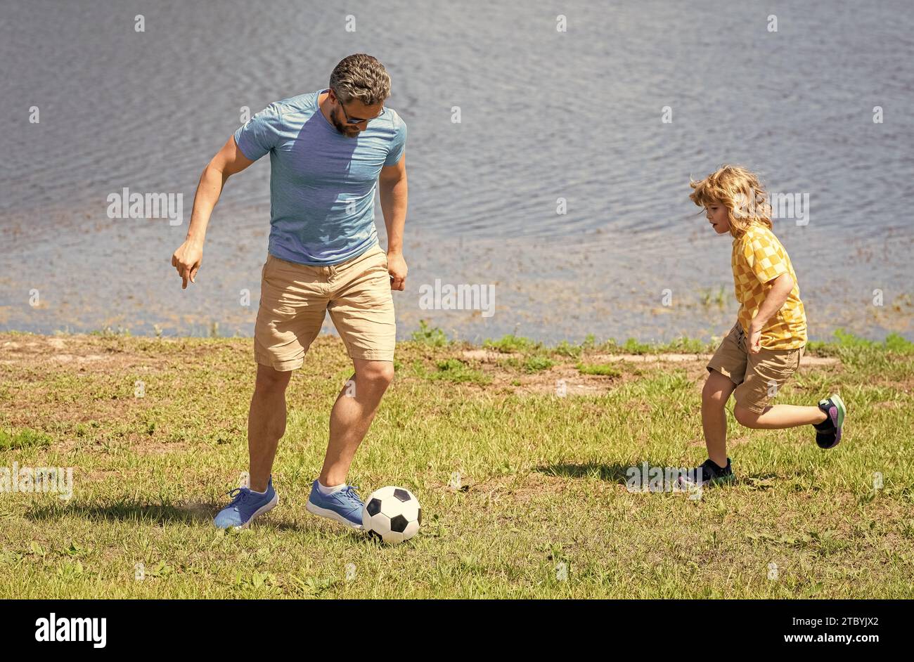 dad and son playing football during their childhood. Childhood memories ...