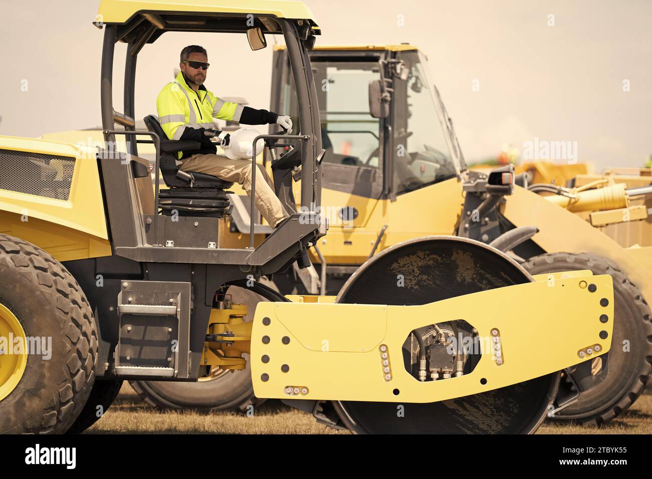 construction machinery worker at roller. machinery in a manufacturing ...
