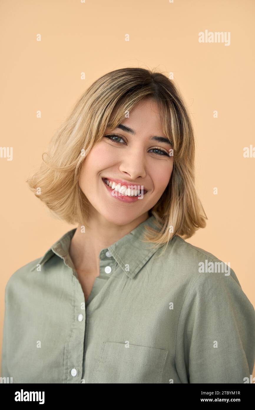 Happy gen z blonde student girl looking at camera isolated on beige ...