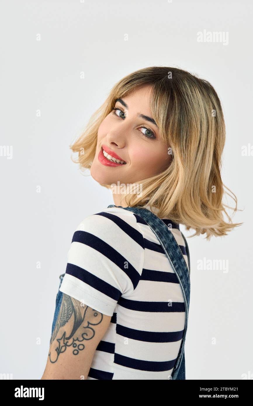 Smiling gen z blonde girl with tattoos standing isolated on white ...