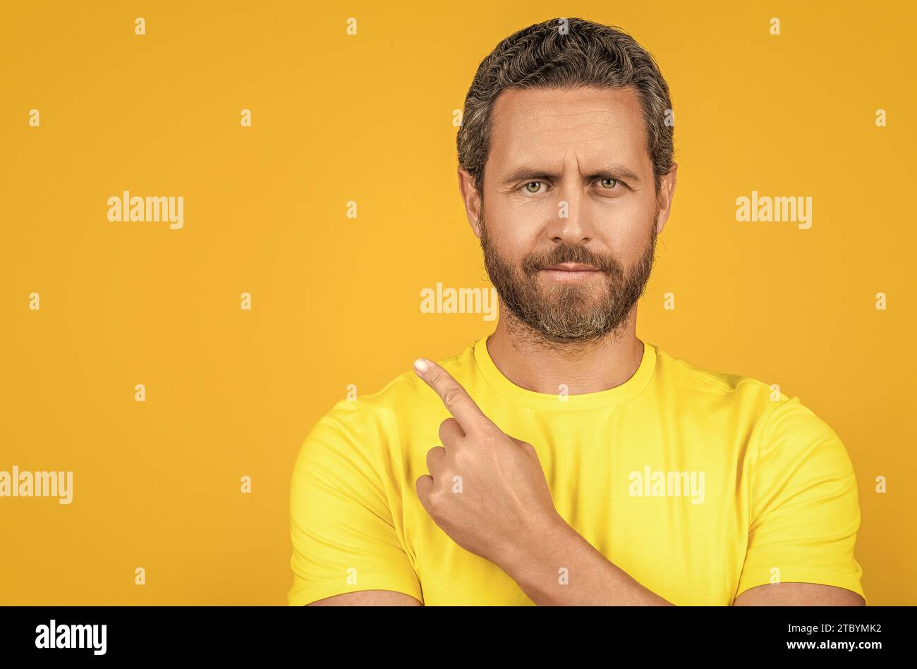 portrait of man pointing at advertisement offer on background. man ...