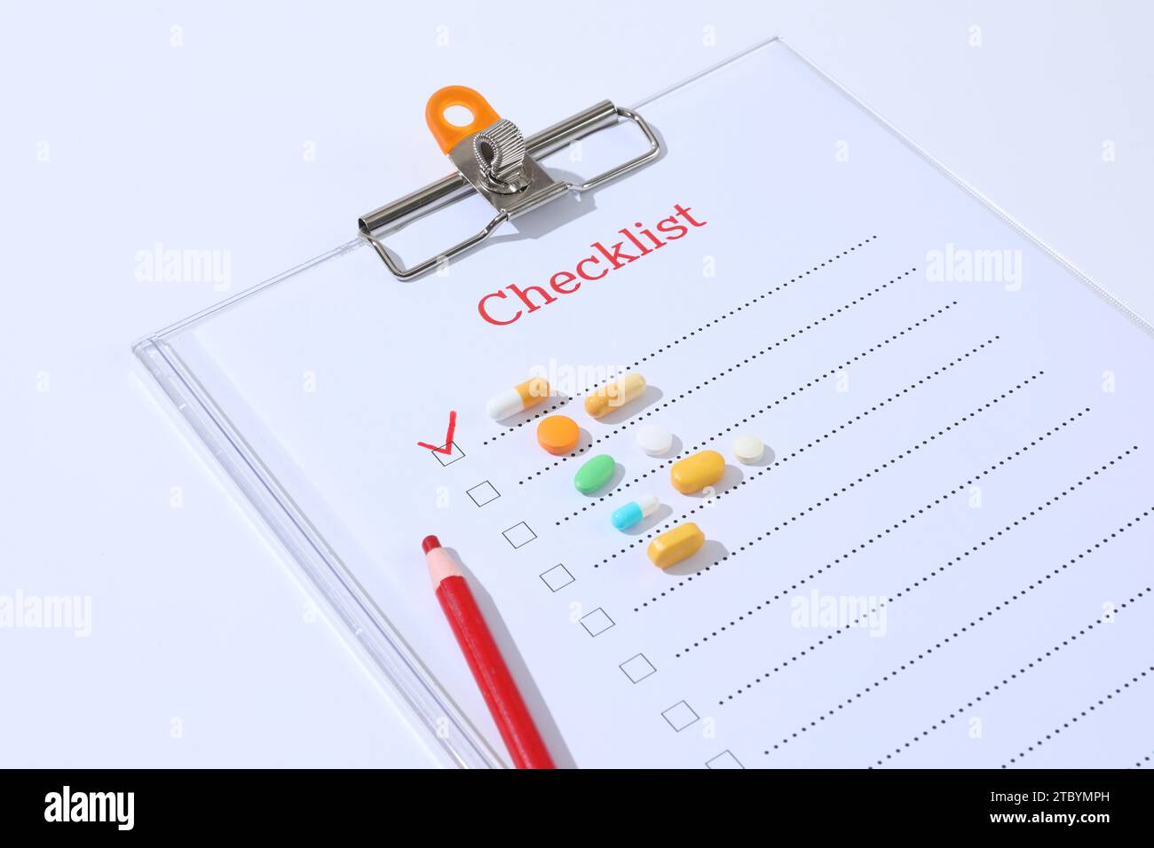 Different medical pills lay with red pen and checklist. Concept of ...
