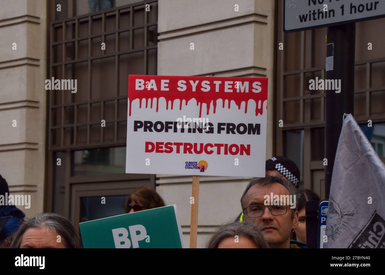 London, England, UK. 9th Dec, 2023. A protester holds a sign accusing ...