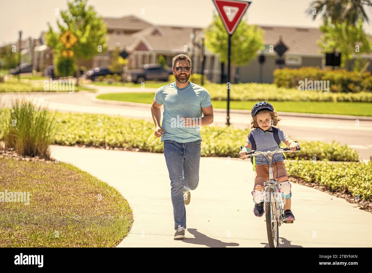 father and son on bicycle at fathers day. active father setting a ...