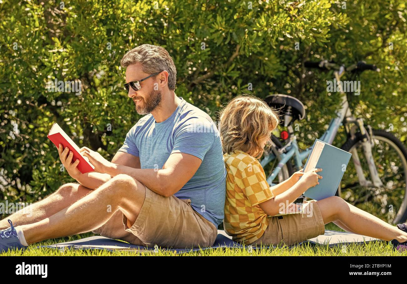 Father and son immersed in outdoor reading adventure. the joy of family ...