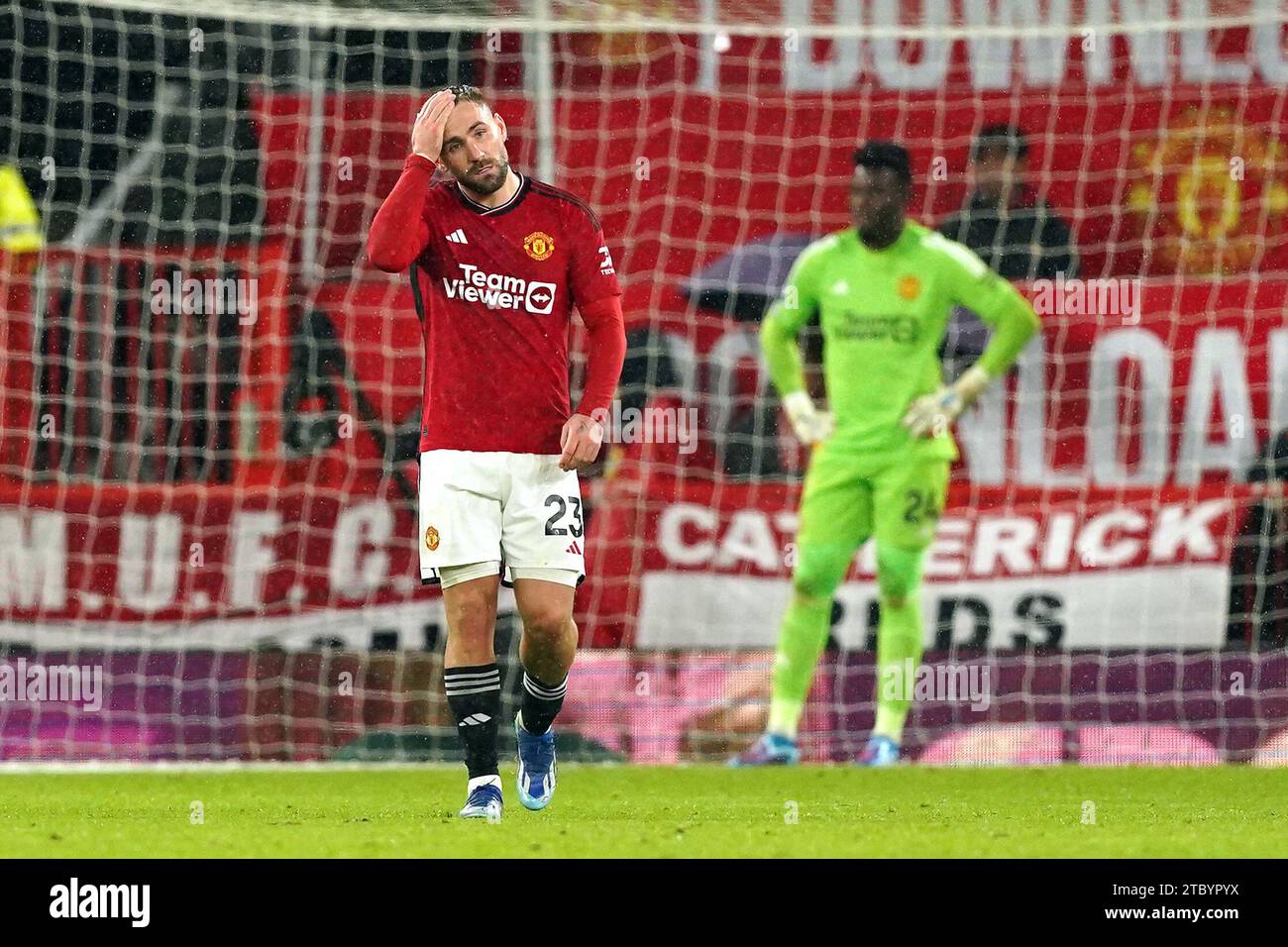 Manchester United's Luke Shaw (left) and goalkeeper Andre Onana look ...