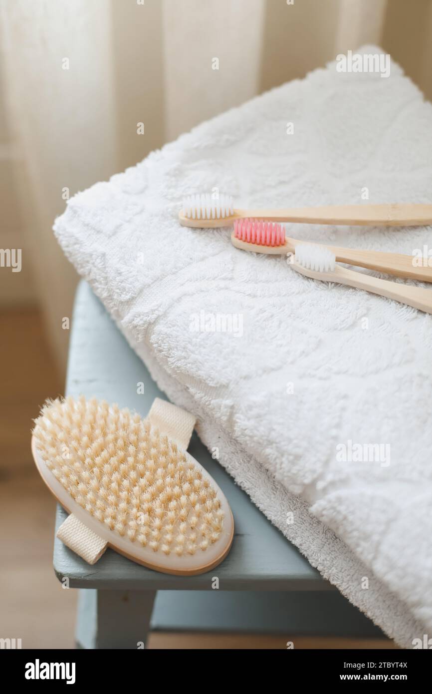 Set of body massage brush and bamboo toothbrushes with white towel ...