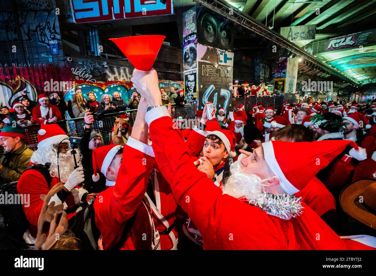 London, UK. 9th Dec, 2023. The Santacon Christmas walk in London. An ...