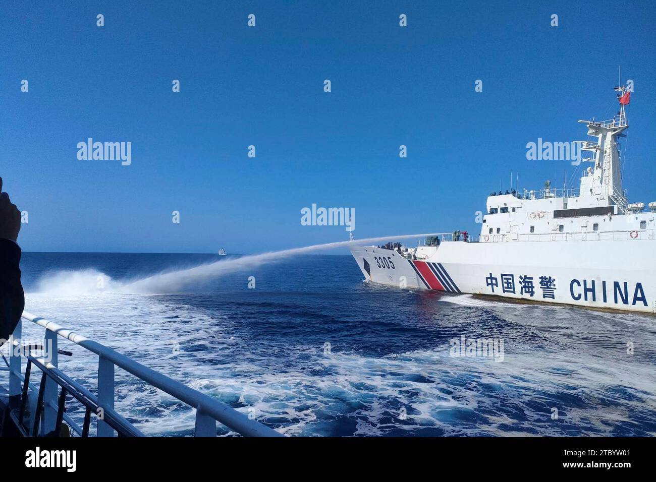 In this photo provided by the Philippine Coast Guard, a Chinese Coast Guard ship, right, uses ...