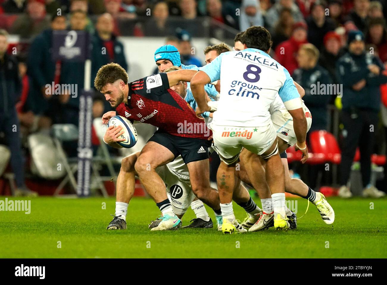 Munster's Alex Nankivell (left) attempts to break free with the ball ...