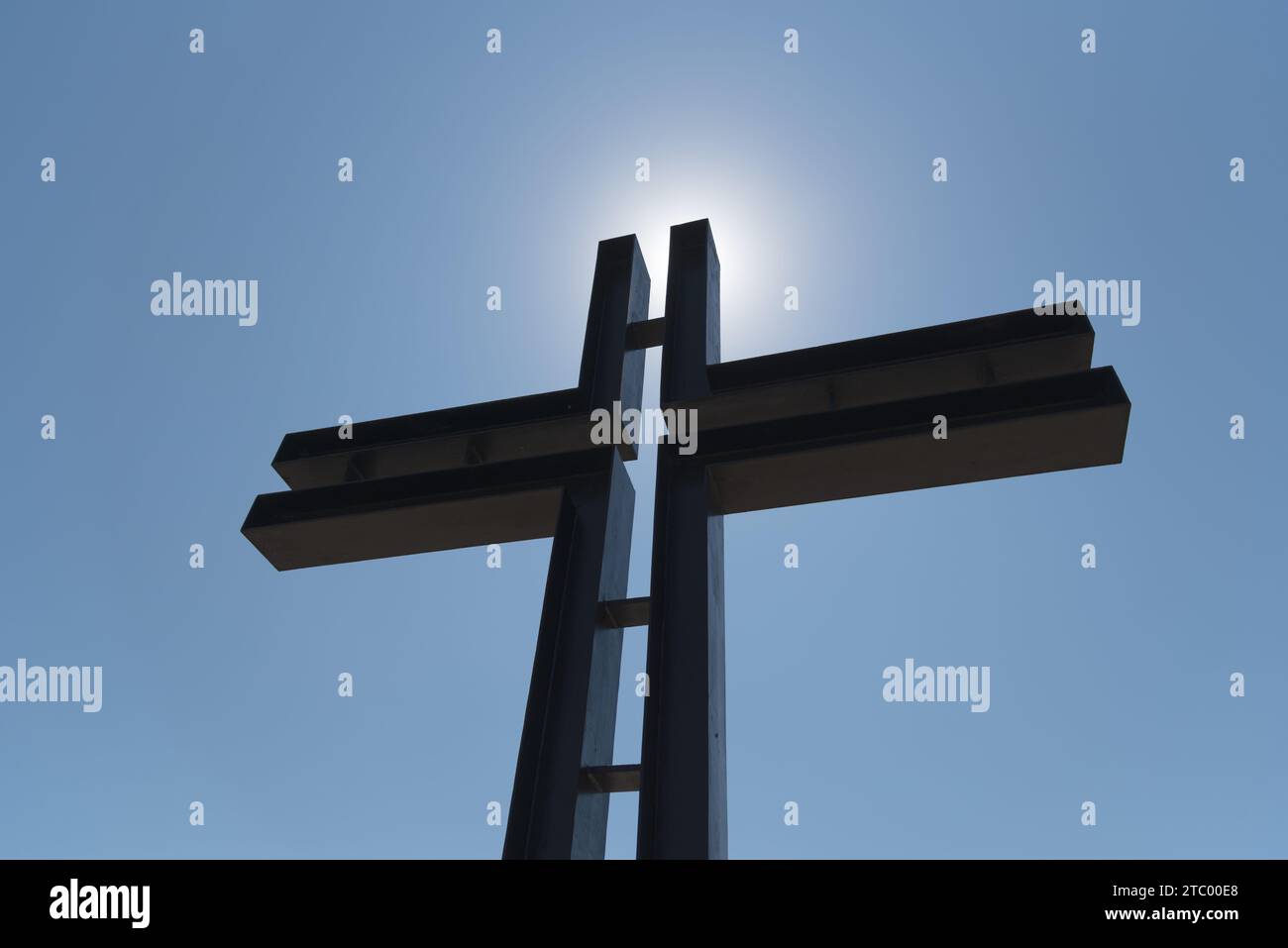 Iron catholic cross against blue sky. Rossoschka German War Cemetery ...