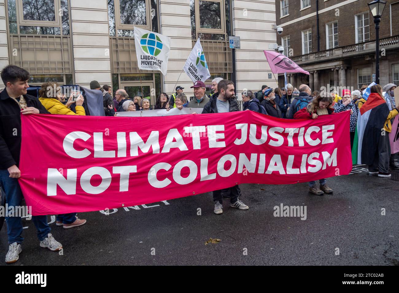 London, UK. 9 Dec 2023. 'Climate Justice Not Colonialism' banner ...