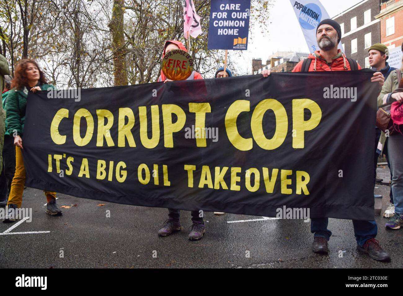 London, UK. 09th Dec, 2023. Protesters hold a banner which states ...