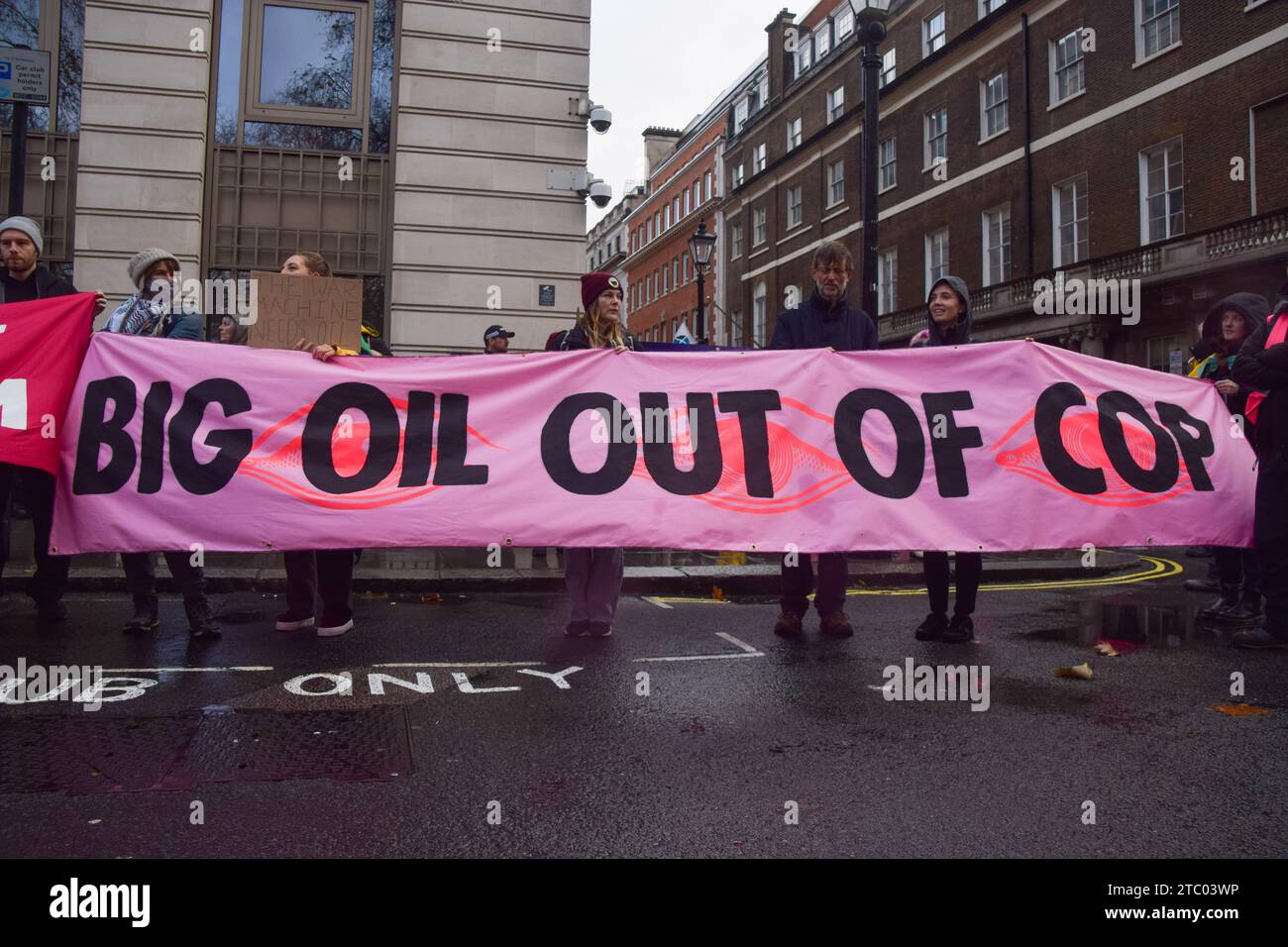 London, UK. 09th Dec, 2023. Protesters hold a banner which states 'Big ...