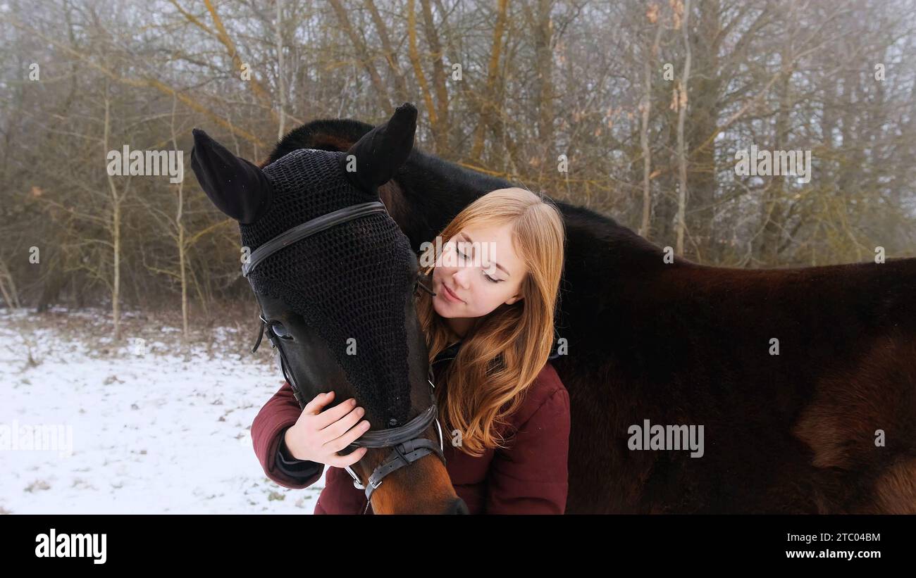 A young beautiful girl hugs a horse in nature in the fog Stock Photo ...