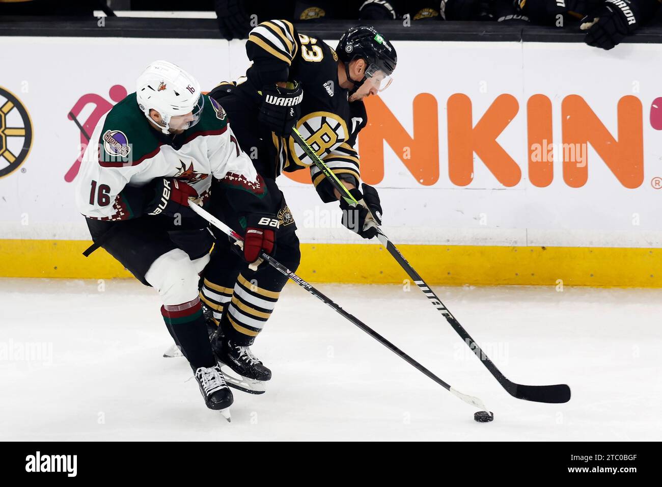 Boston Bruins' Brad Marchand (63) and Arizona Coyotes' Jason Zucker (16 ...