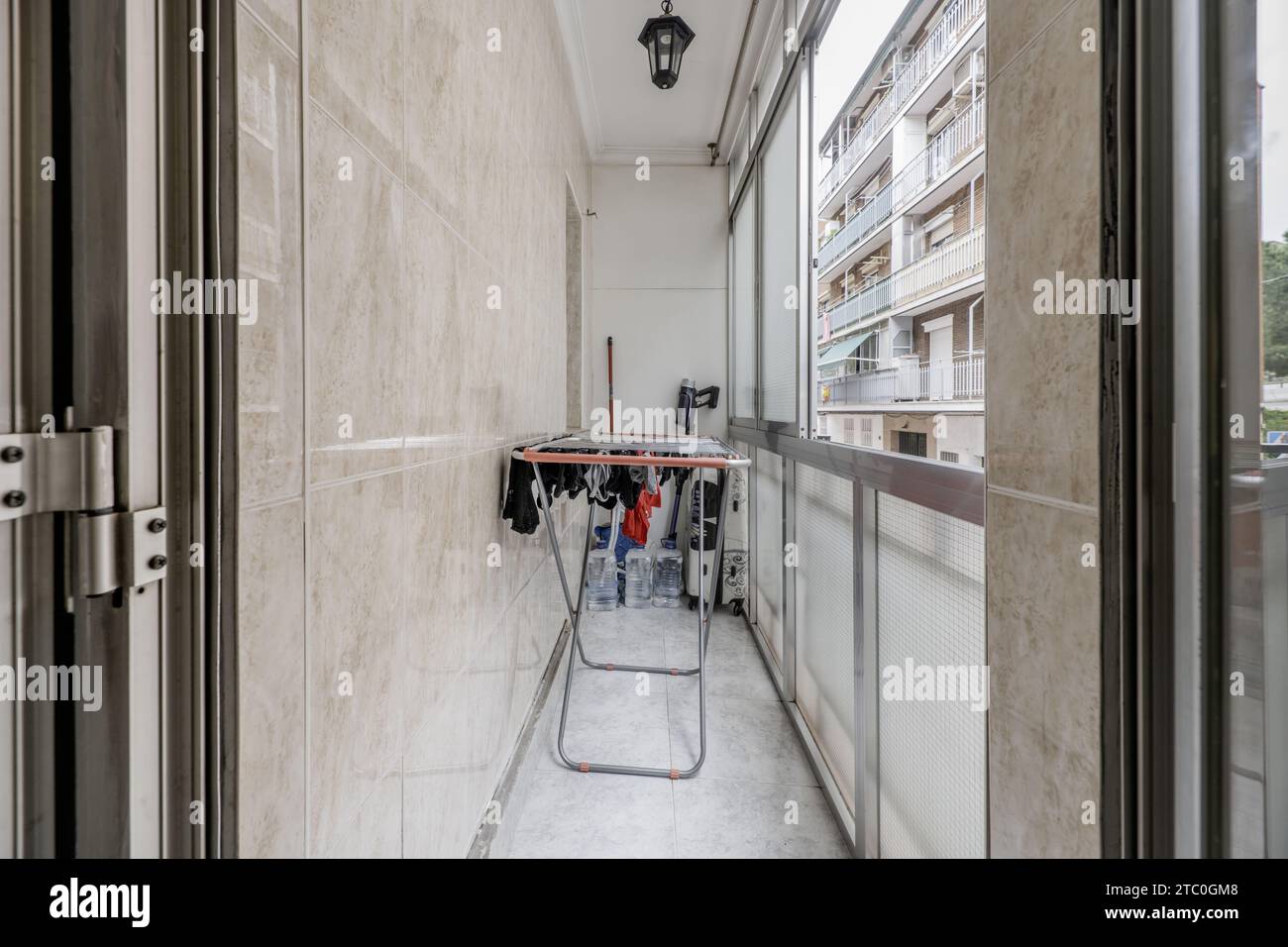 A narrow terrace with aluminum and glass windows Stock Photo - Alamy
