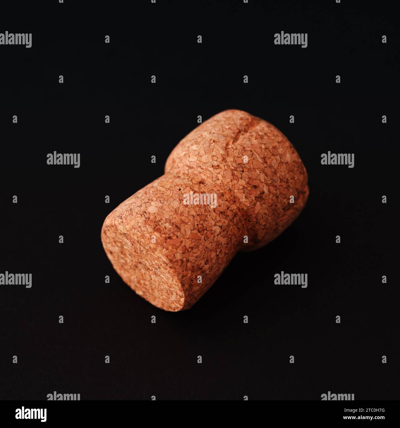 A champagne cork lying on a black background Stock Photo - Alamy