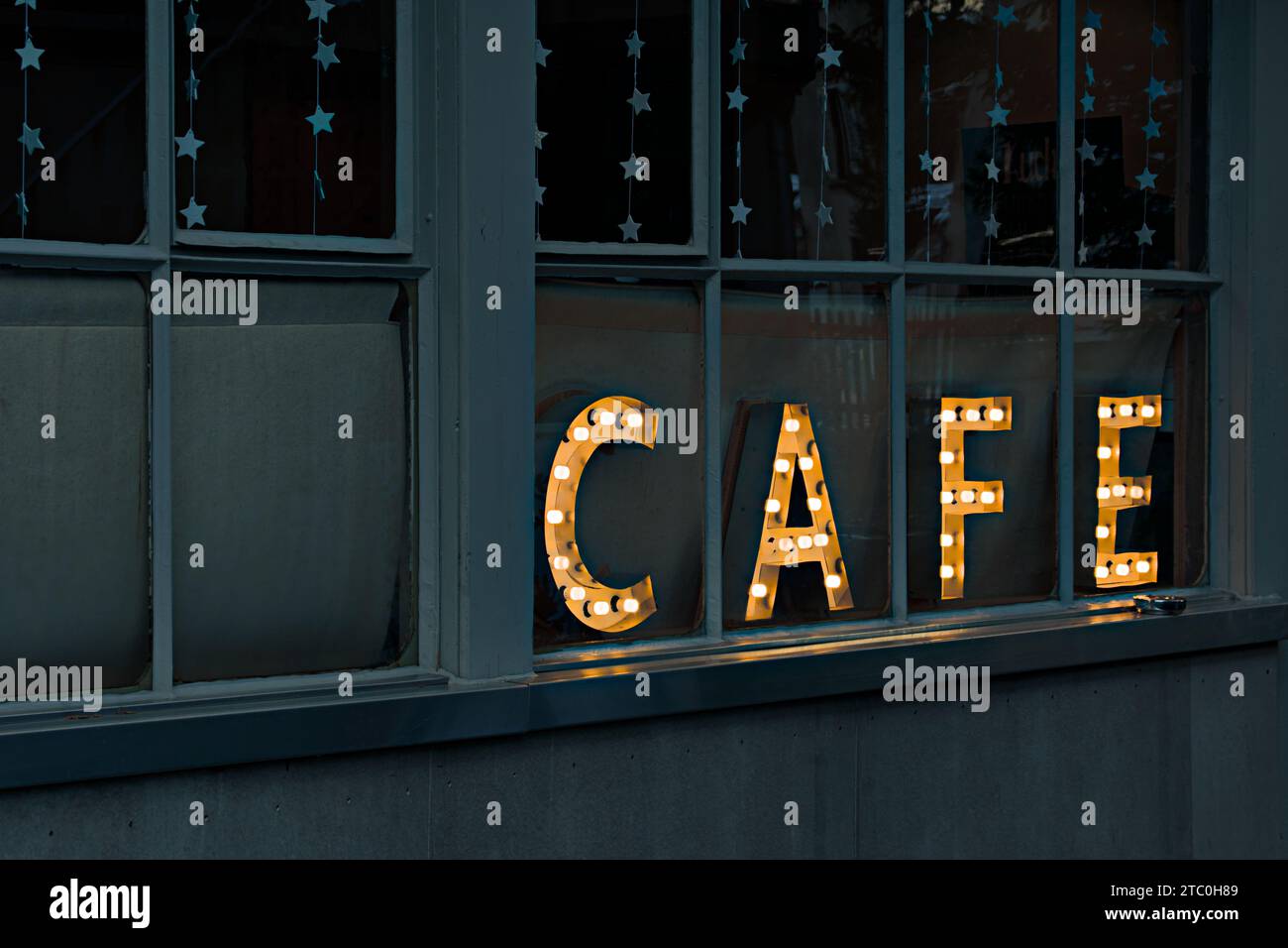 A nice little cafe in the evening hours with classic illuminated ...