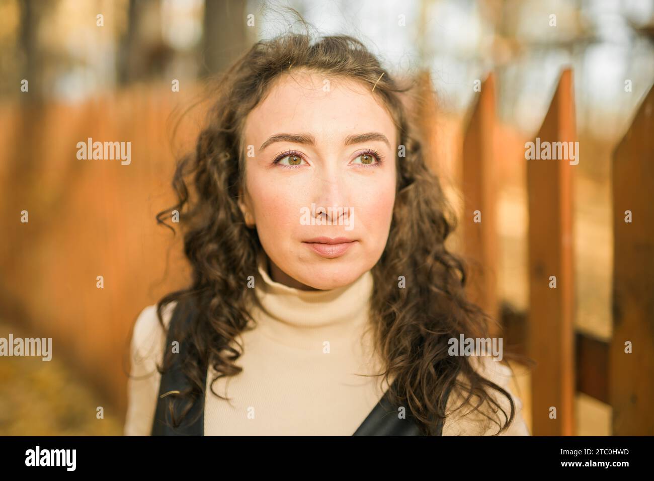 Autumn portrait of a beautiful happy curly woman in fall season copy ...