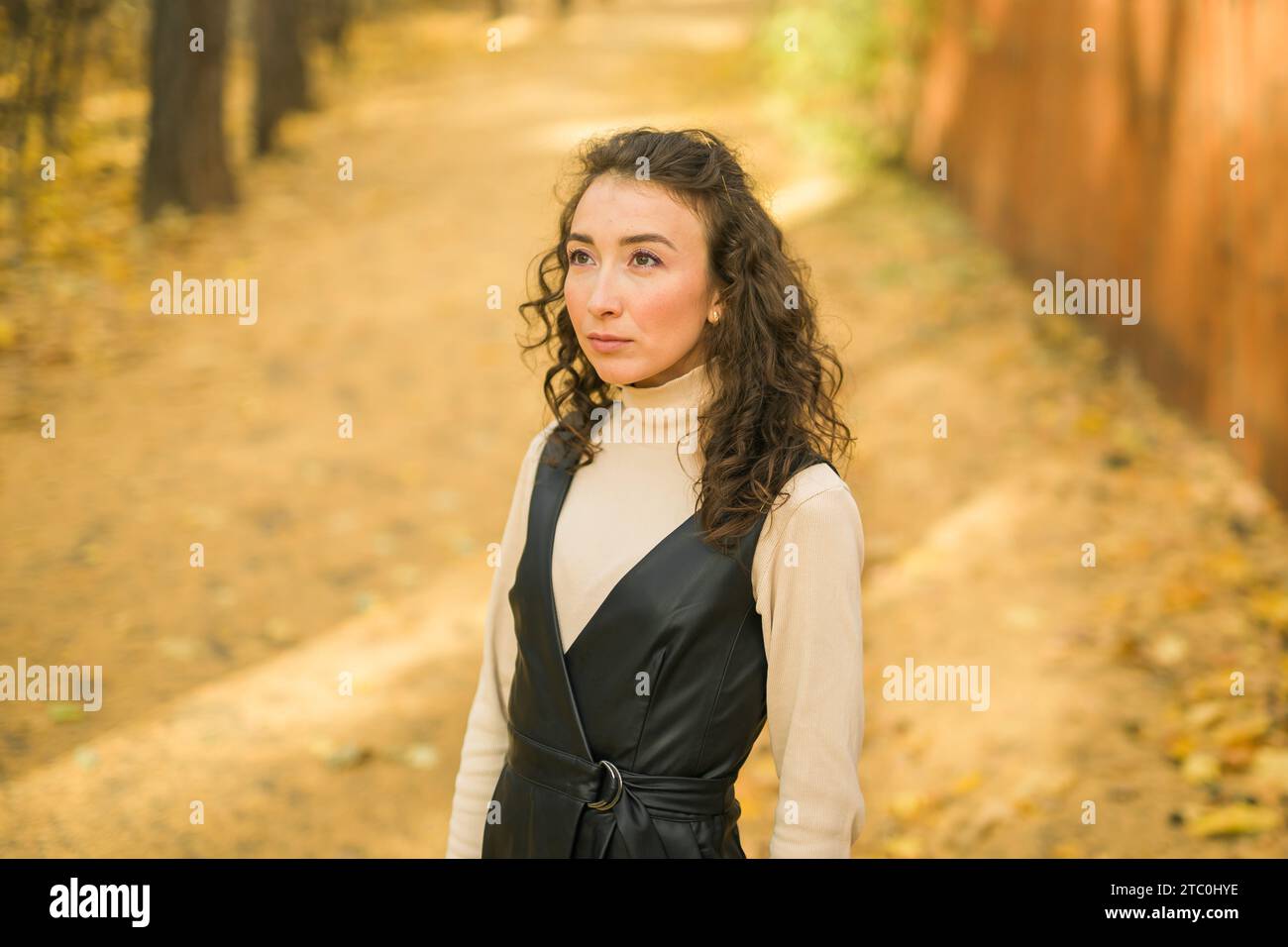 Autumn portrait of a beautiful happy curly woman in fall season copy ...