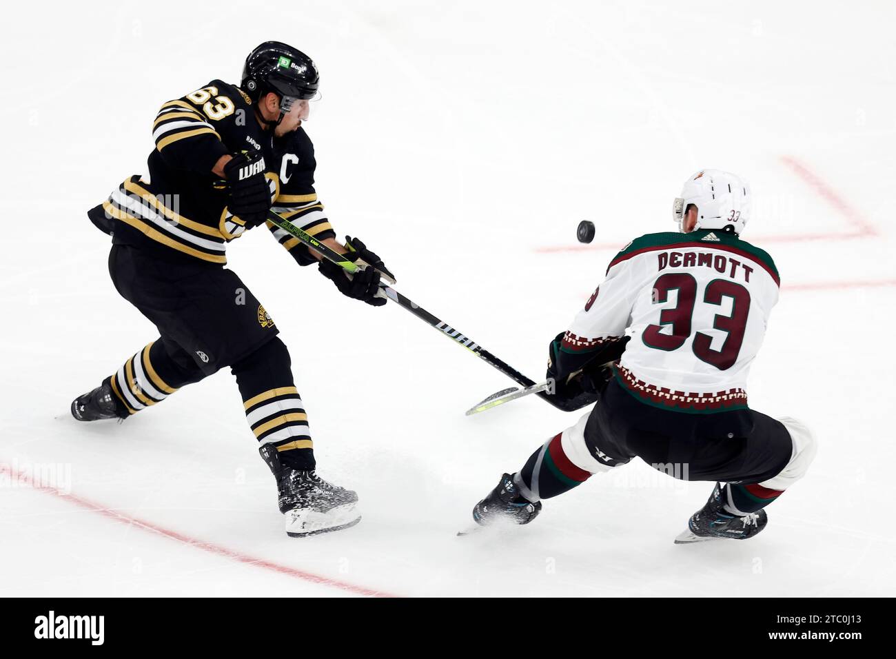 Boston Bruins' Brad Marchand (63) and Arizona Coyotes' Travis Dermott ...