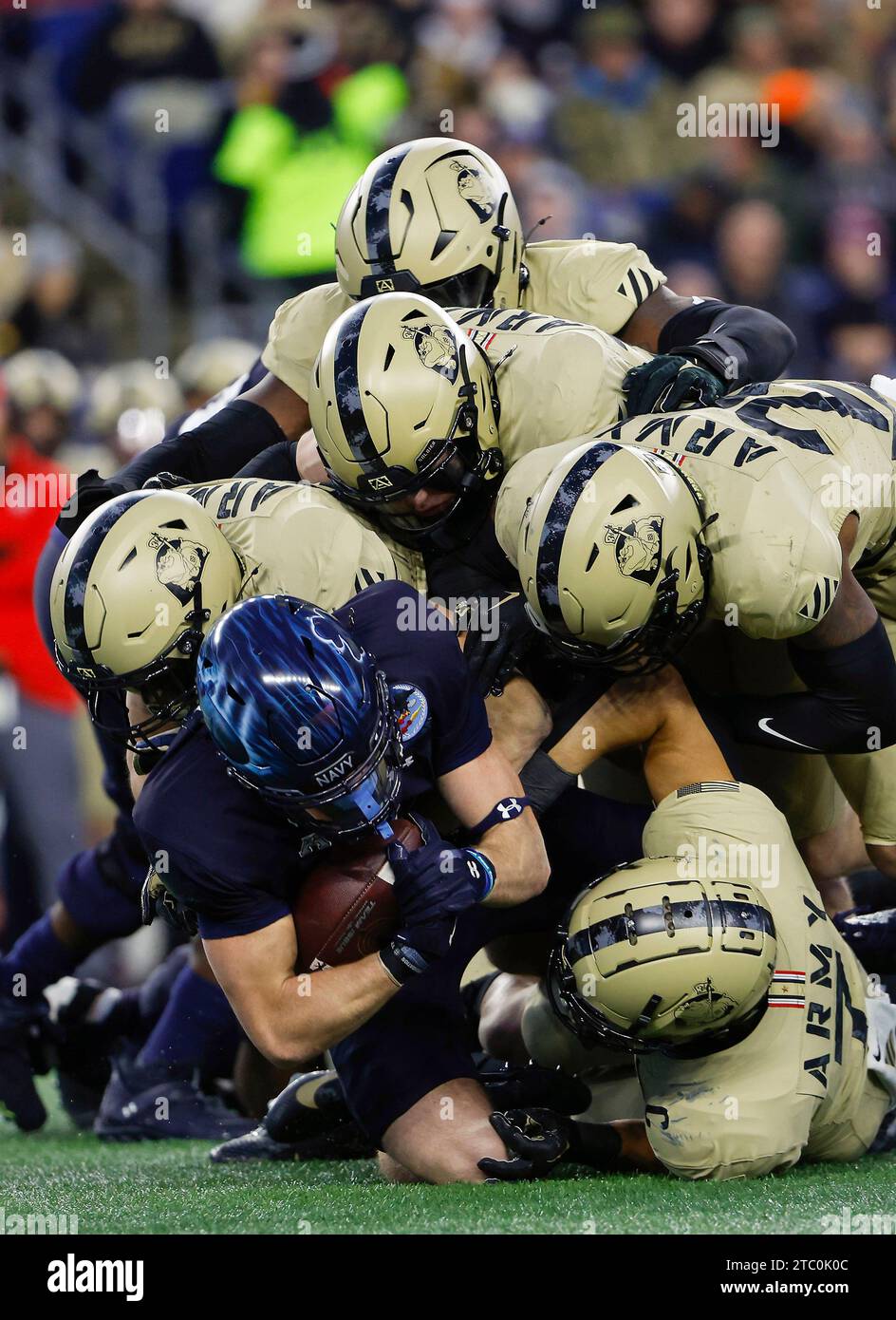 Navy fullback Alex Tecza is gang tackled by Army defenders during the ...
