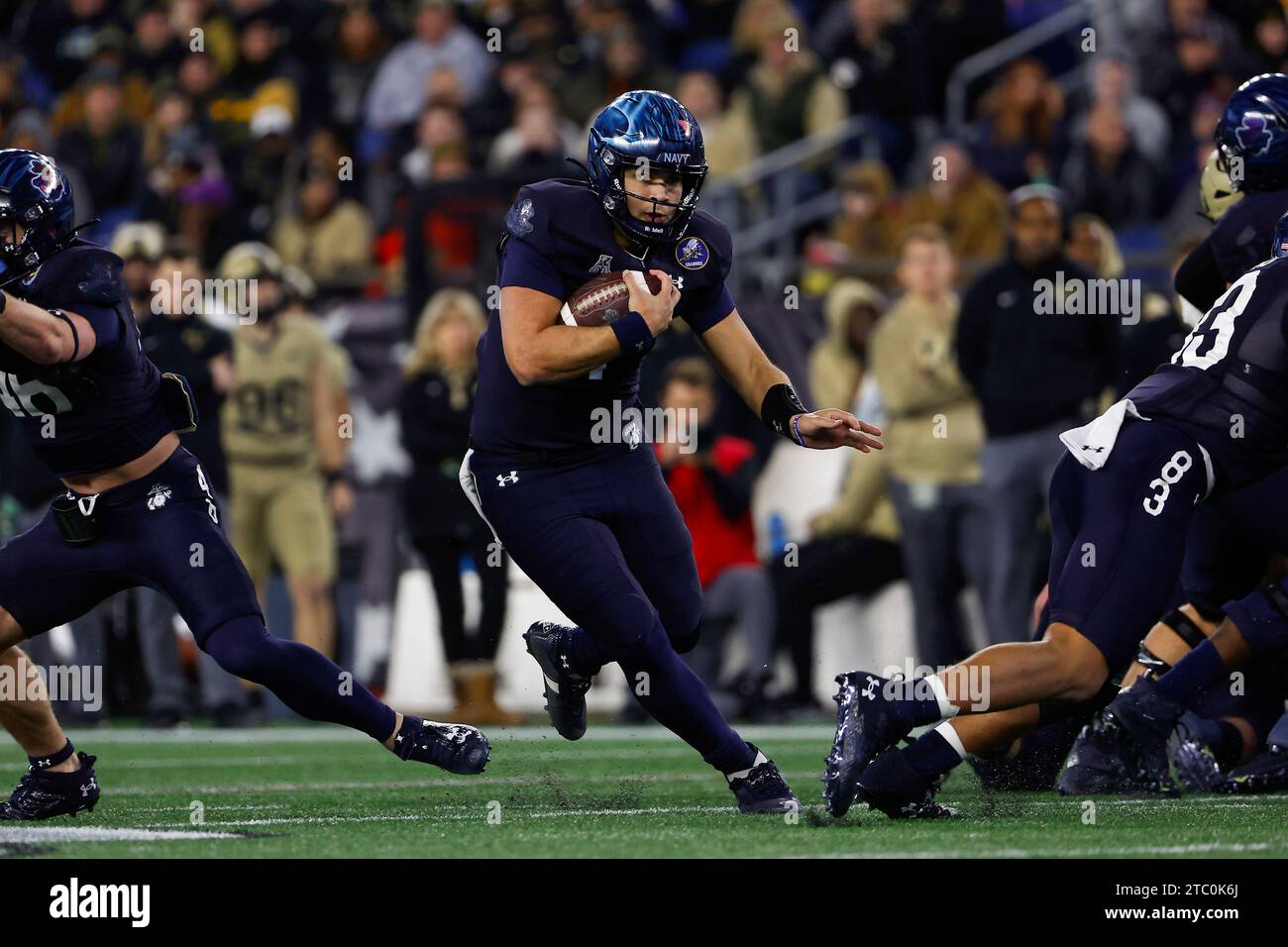 Navy quarterback Xavier Arline runs through a hole in the Army defense ...