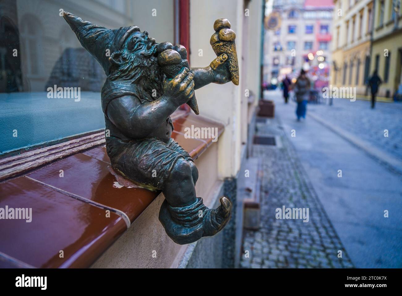 Wrocław, poland - 08 December 2023: Dwarf named Bartonik sitting on a window still and eating ...
