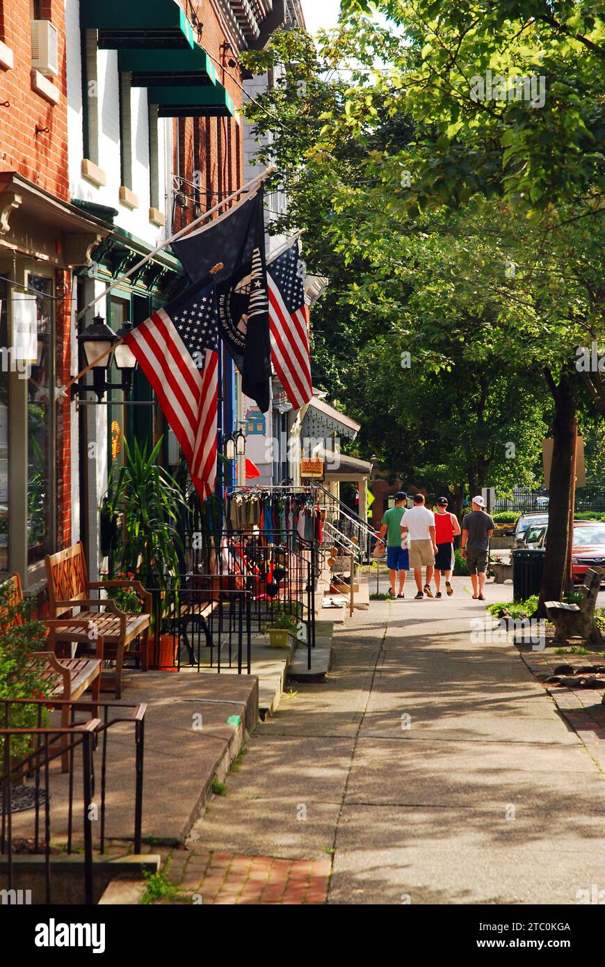 American flags hang from the business that line the main street n Cold ...