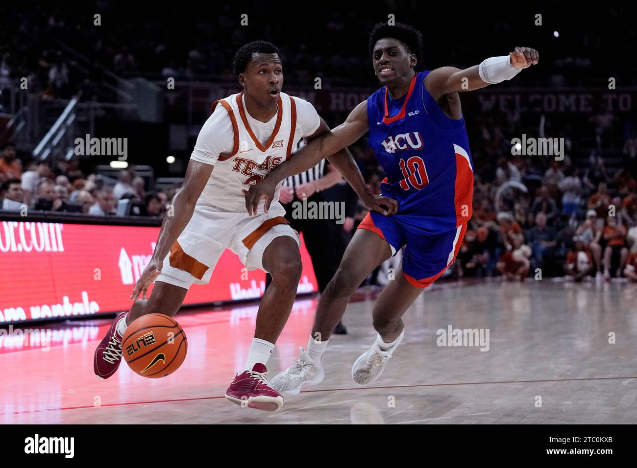 Texas guard Max Abmas (3) drives around Houston Christian guard Marcus ...