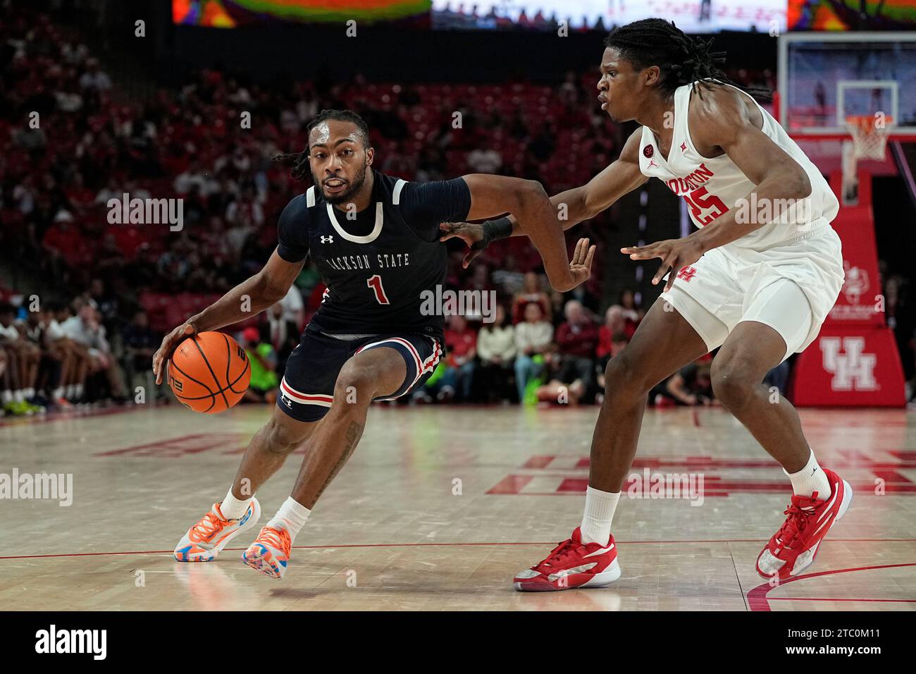 Jackson State forward Zeke Cook (1) drives past Houston forward Joseph ...