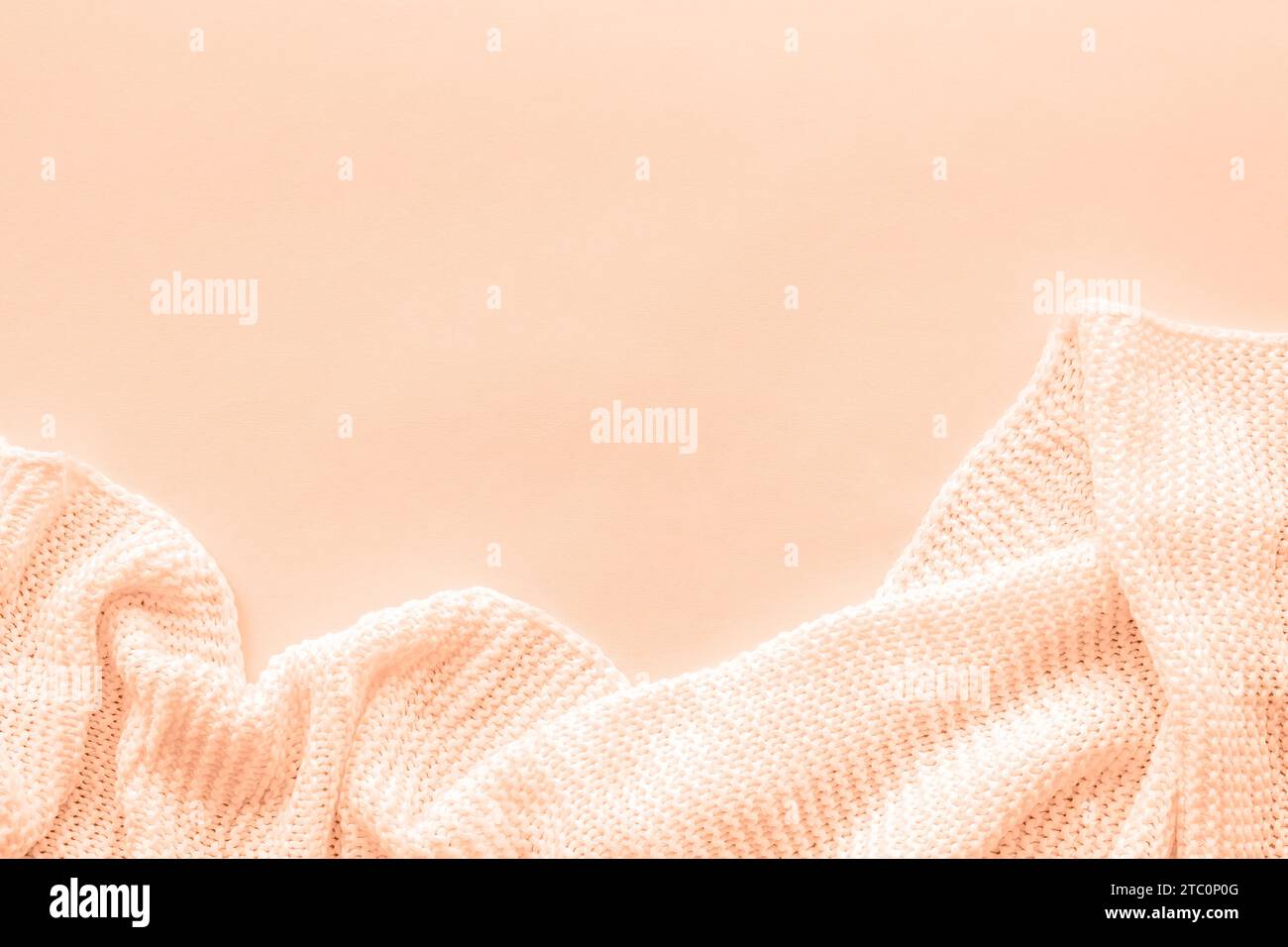 Knitted blanket on peachy background. Top view, flat lay, copy space ...