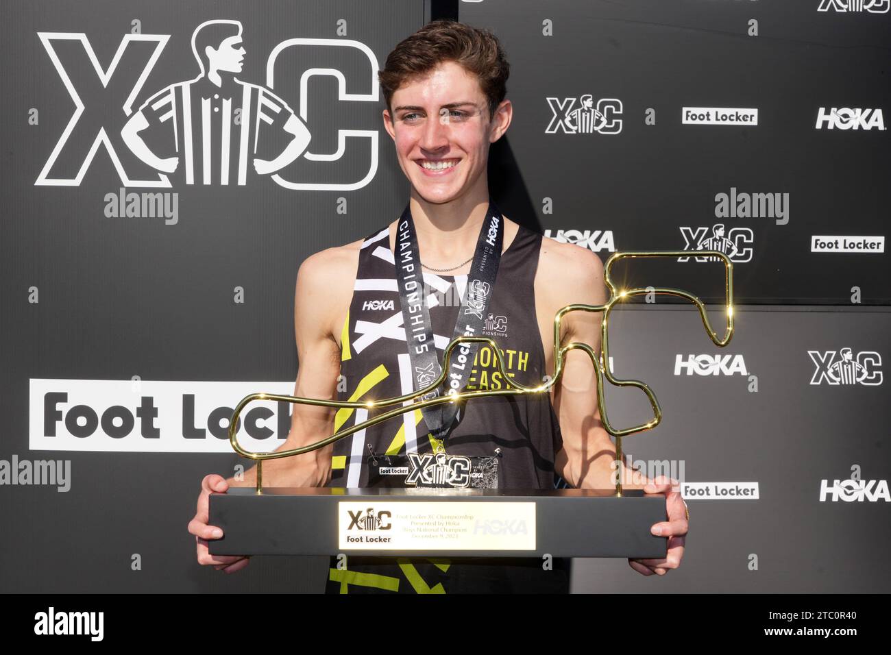 Drew Griffith poses with trophy after winning the boys race in 15:06.9 ...