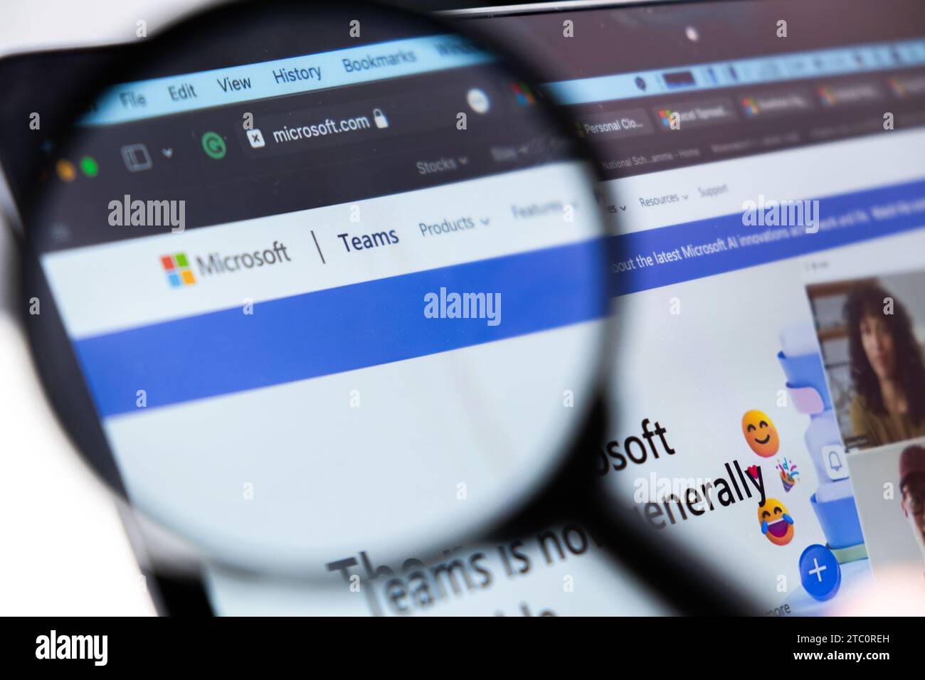 Microsoft Teams logo enlarged through a magnifying glass on a laptop ...