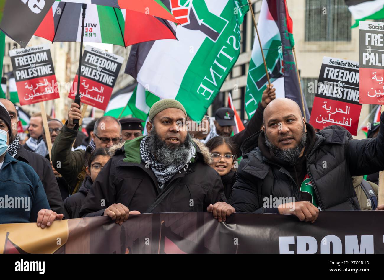London, UK. 9 Dec 2023: Pro-Palestinian muslim protesters hold a banner ...
