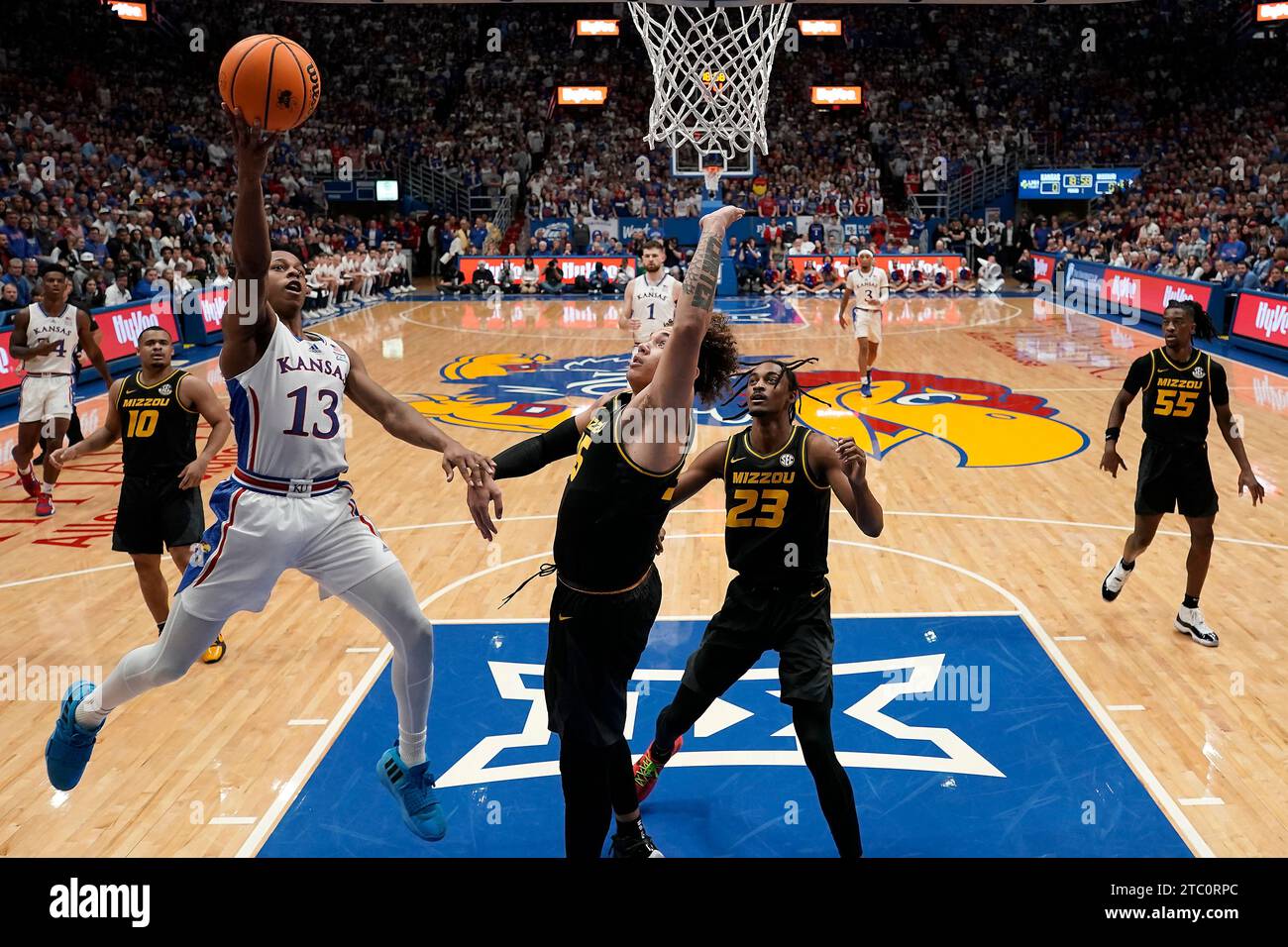 Kansas guard Elmarko Jackson (13) shoots over Missouri forward Noah ...