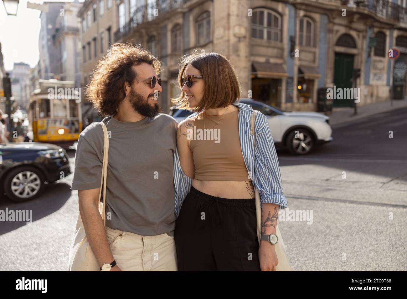 Smiling romantic couple in love looking each other while embracing and ...