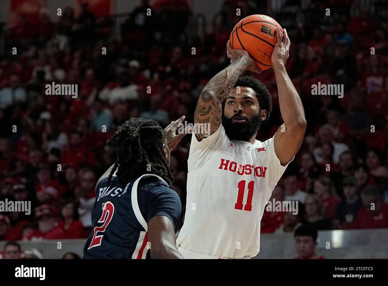 Houston guard Damian Dunn (11) shoots over Jackson State guard Ken ...