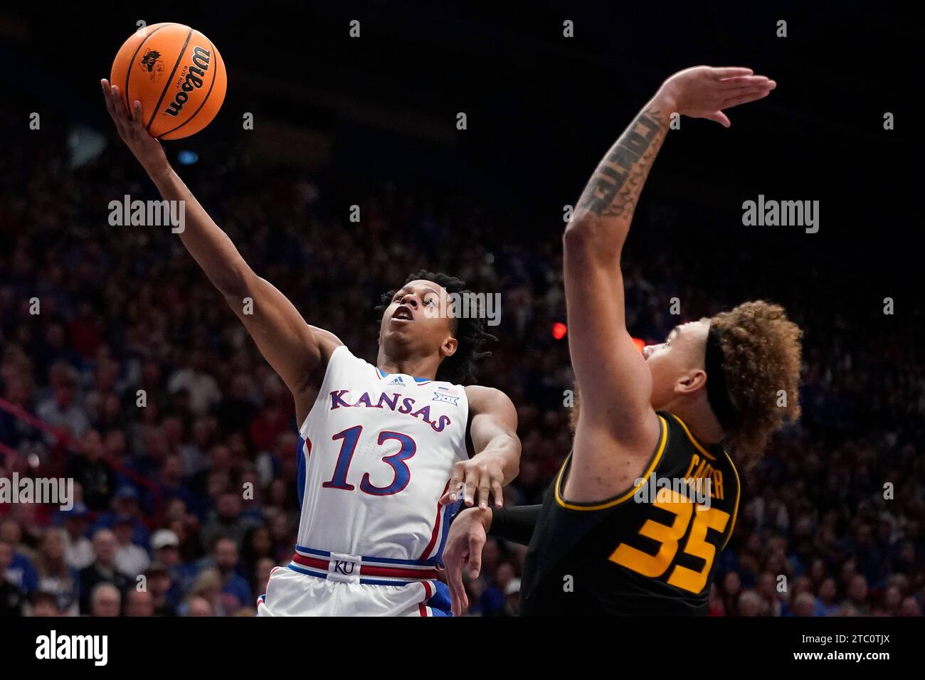 Kansas guard Elmarko Jackson (13) shoots over Missouri forward Noah ...