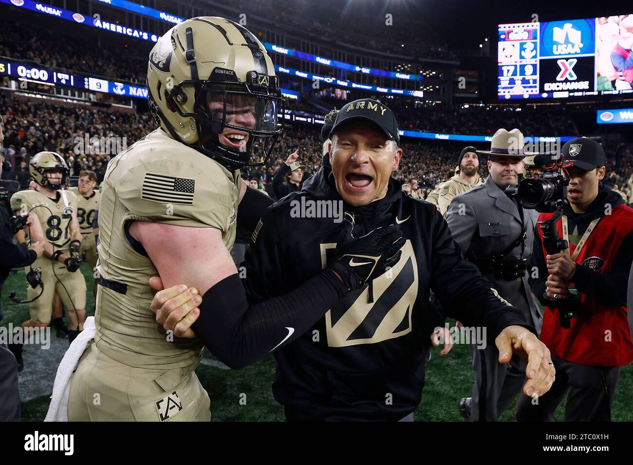 Army coach Jeff Monken celebrates with Max DiDomenico after the team's ...