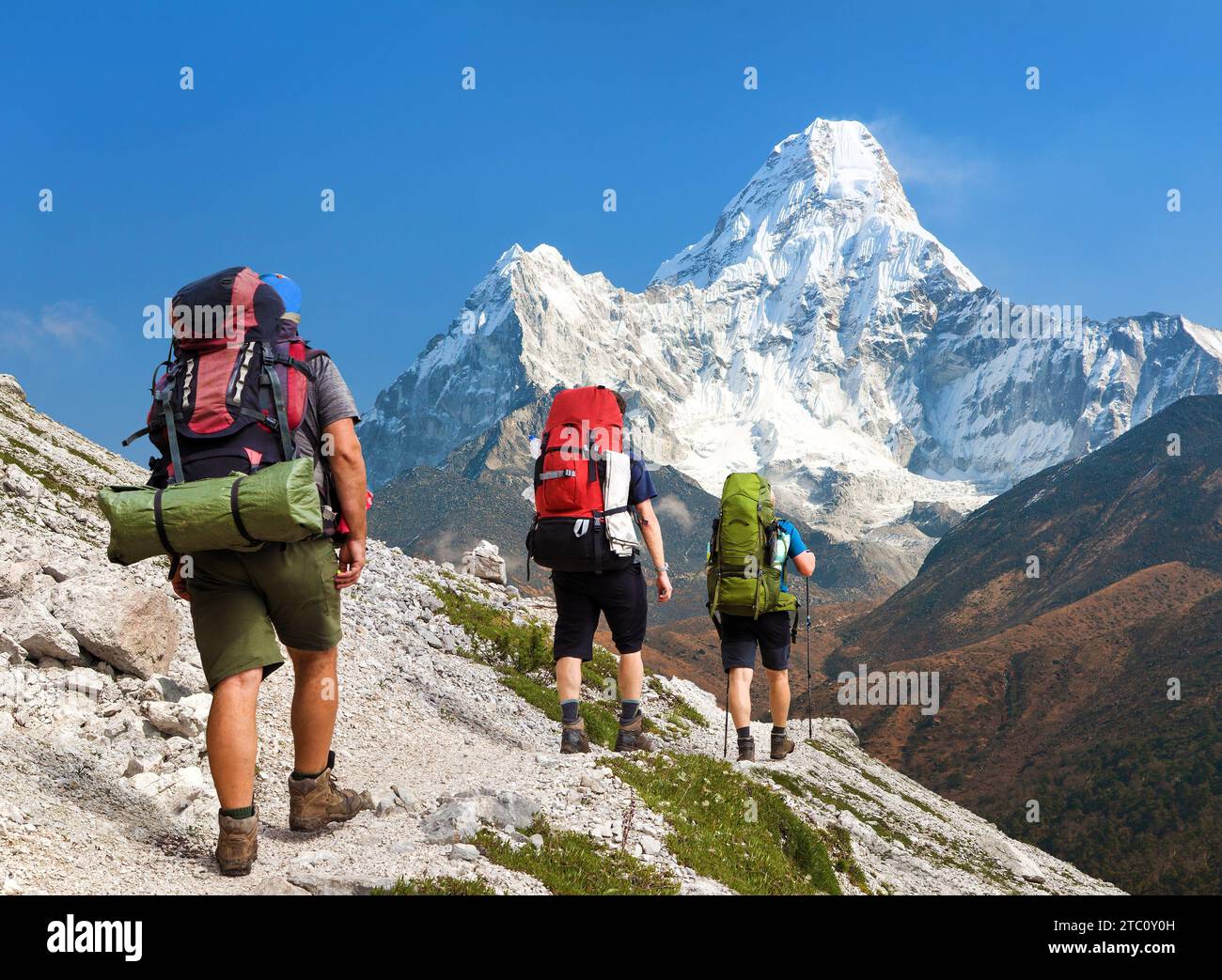 Mount Ama Dablam and three hikers, way to Mt Everest base camp, Khumbu ...