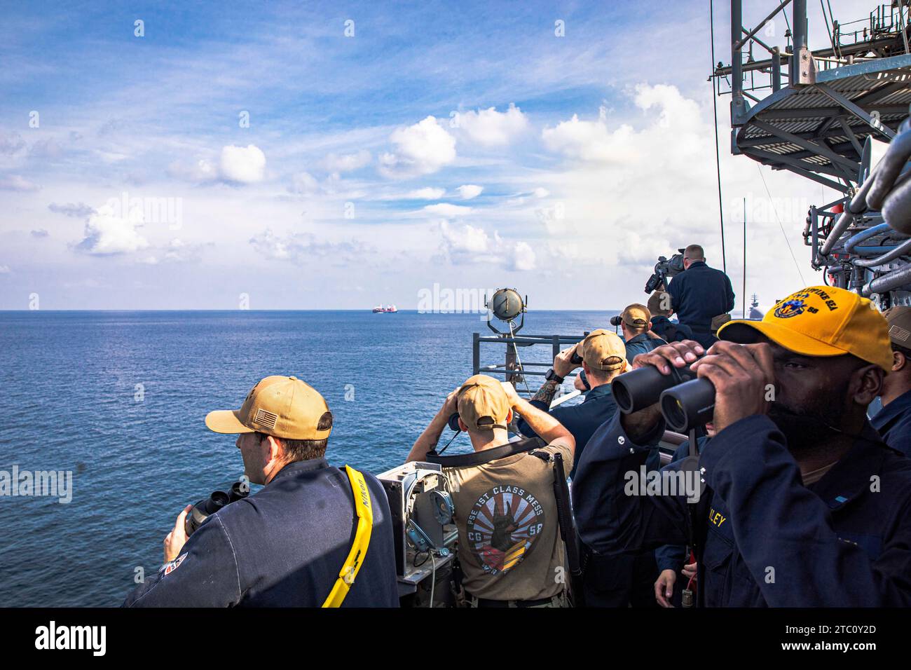 U.S. Navy Sailors scan the surrounding area while transiting the Strait ...