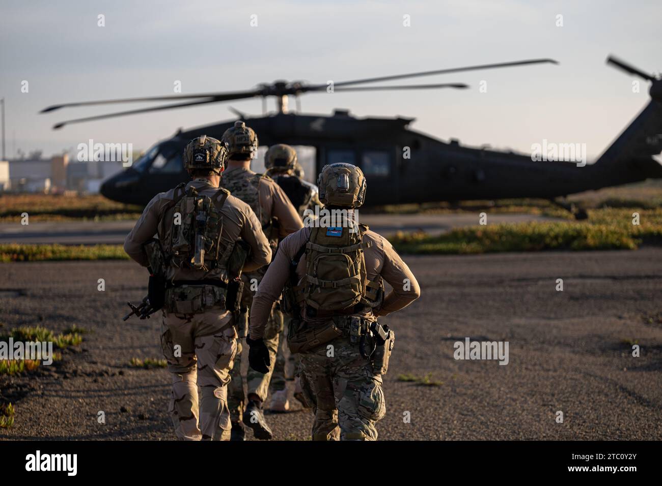 U.S. Naval Special Warfare operators run to a UH-60 Blackhawk operated ...