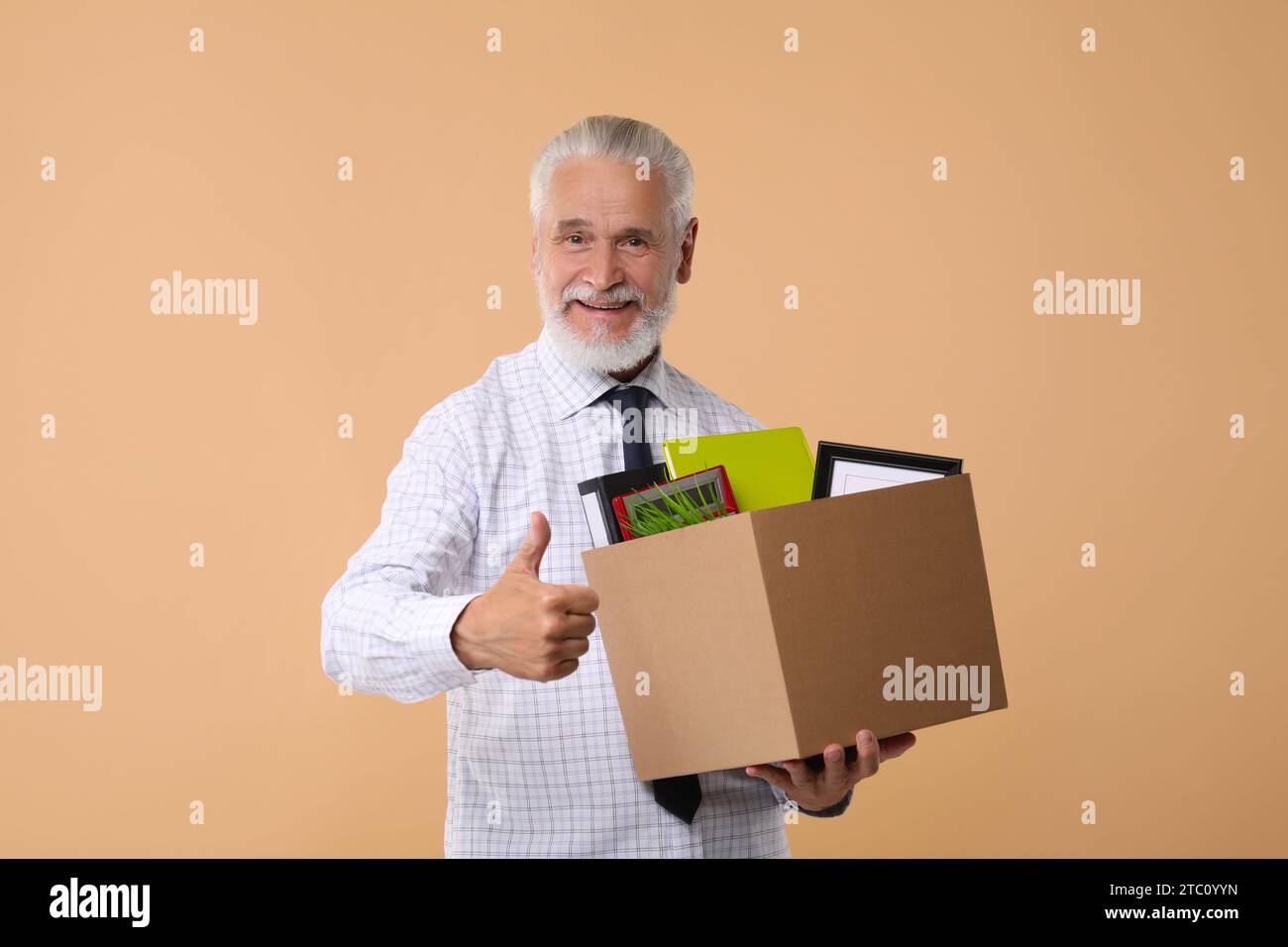 Happy unemployed senior man with box of personal office belongings ...