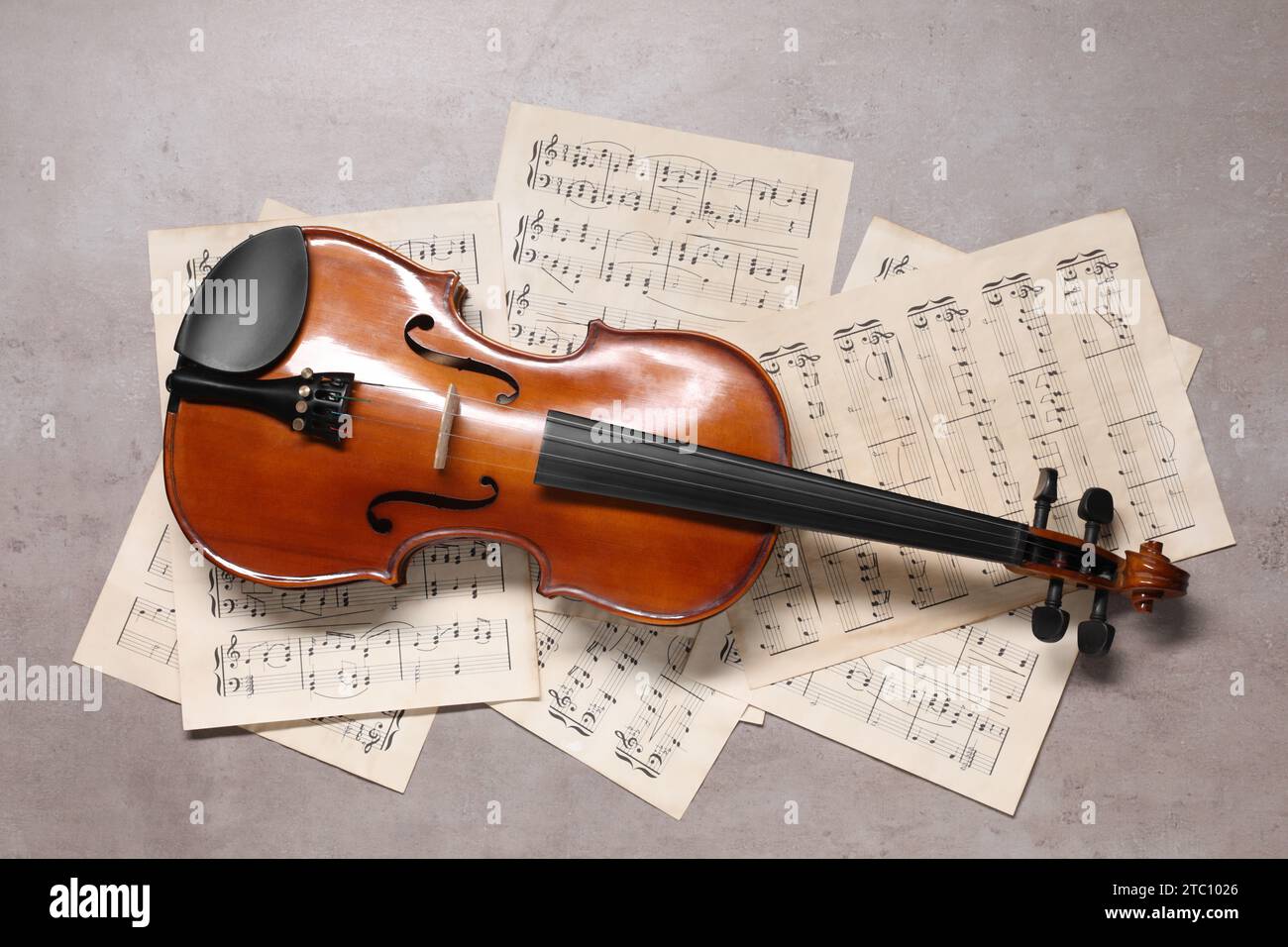 Violin and music sheets on grey table, top view Stock Photo - Alamy