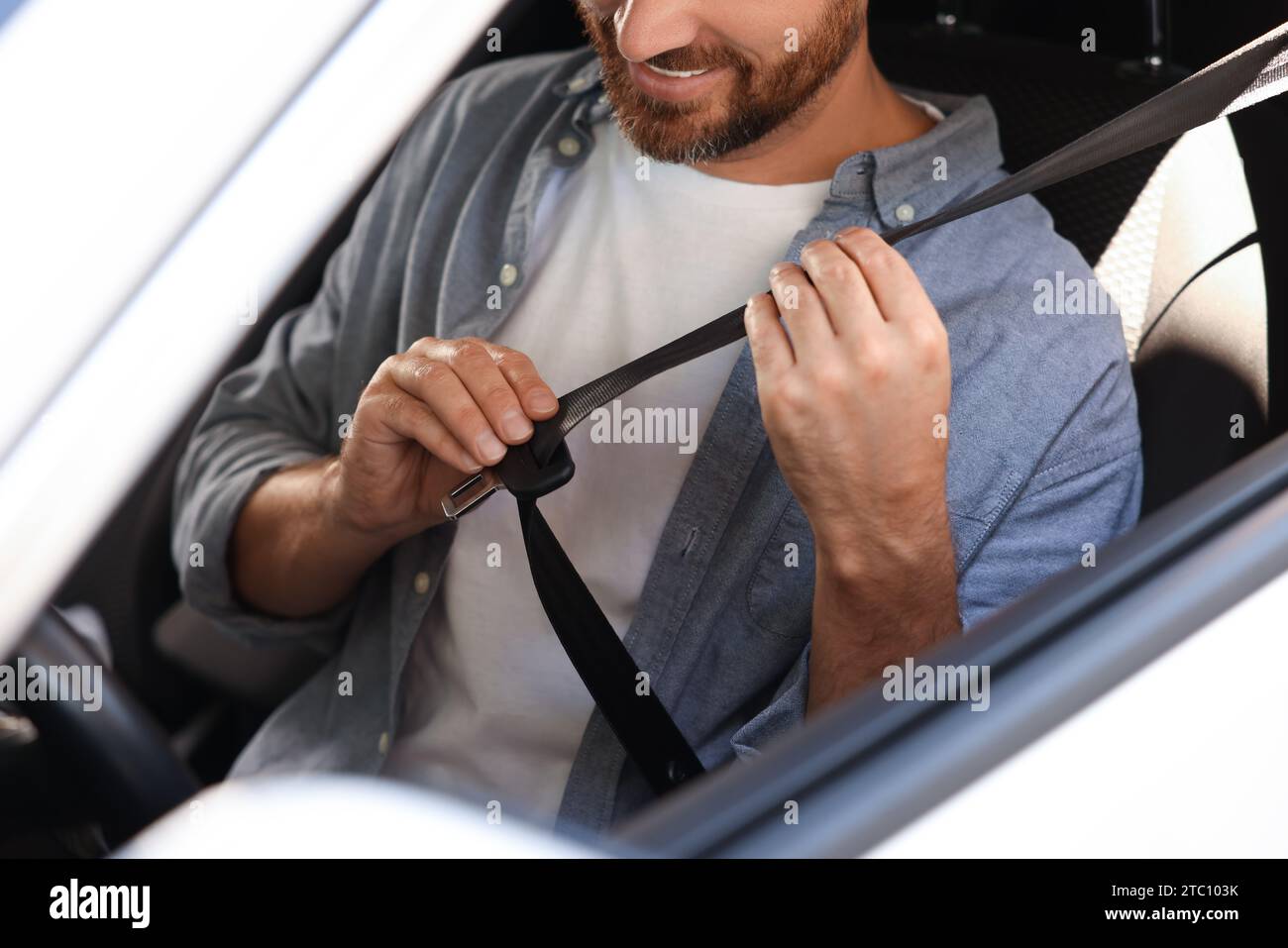 Man pulling seat belt in car, closeup Stock Photo - Alamy