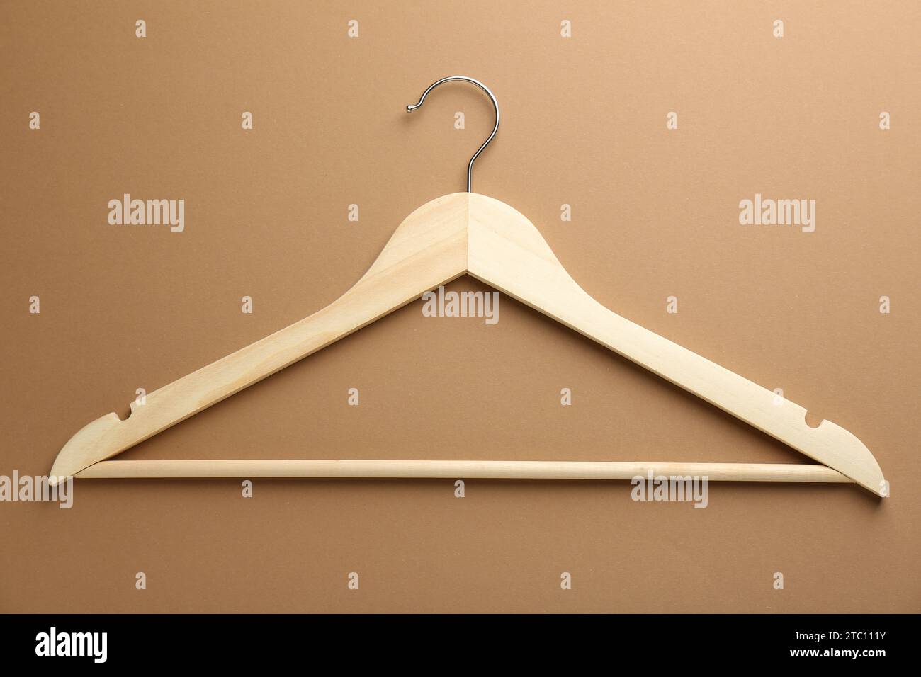 Empty wooden hanger on brown background, top view Stock Photo - Alamy